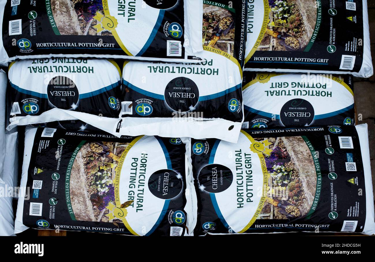 A stack of bags of horticultural potting grit for aquatic planting and ...