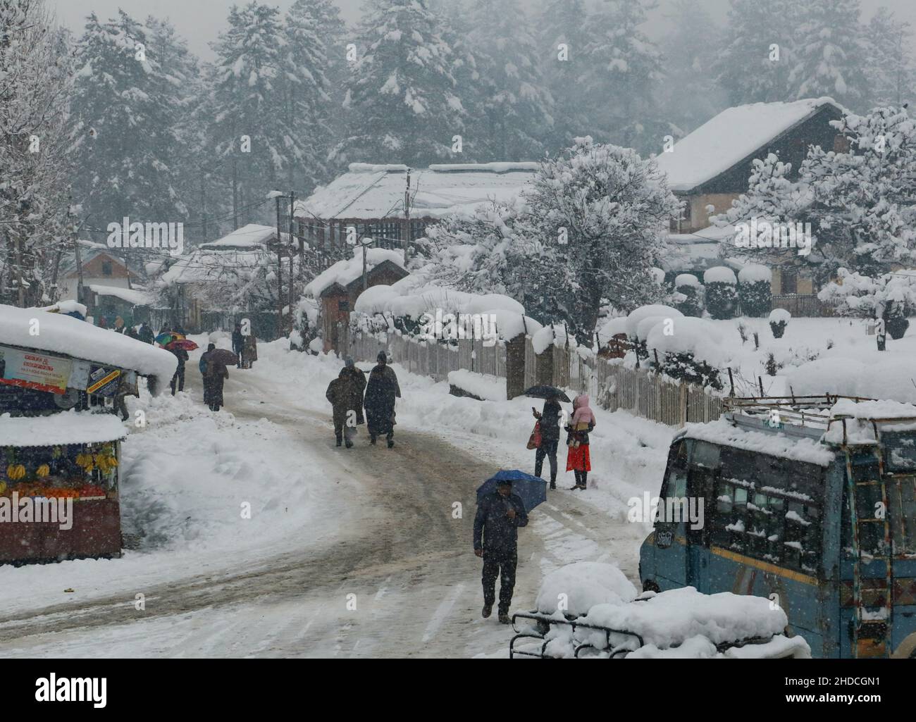 Srinagar, India. 05th Jan, 2022. People walk through a snow-covered ...