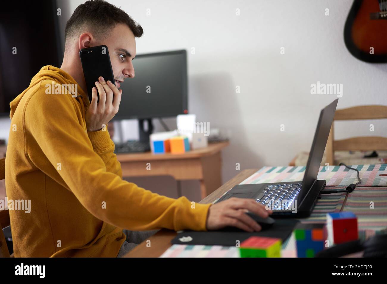 Student working from home with laptop, computer, cellphone and notebook ...