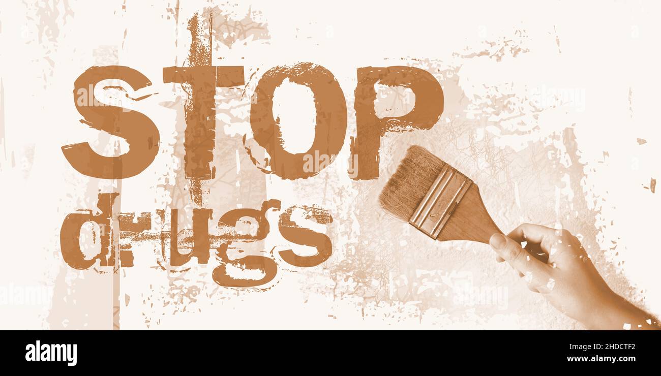 Stop drugs words Painted on light grey wall background and a hand ...