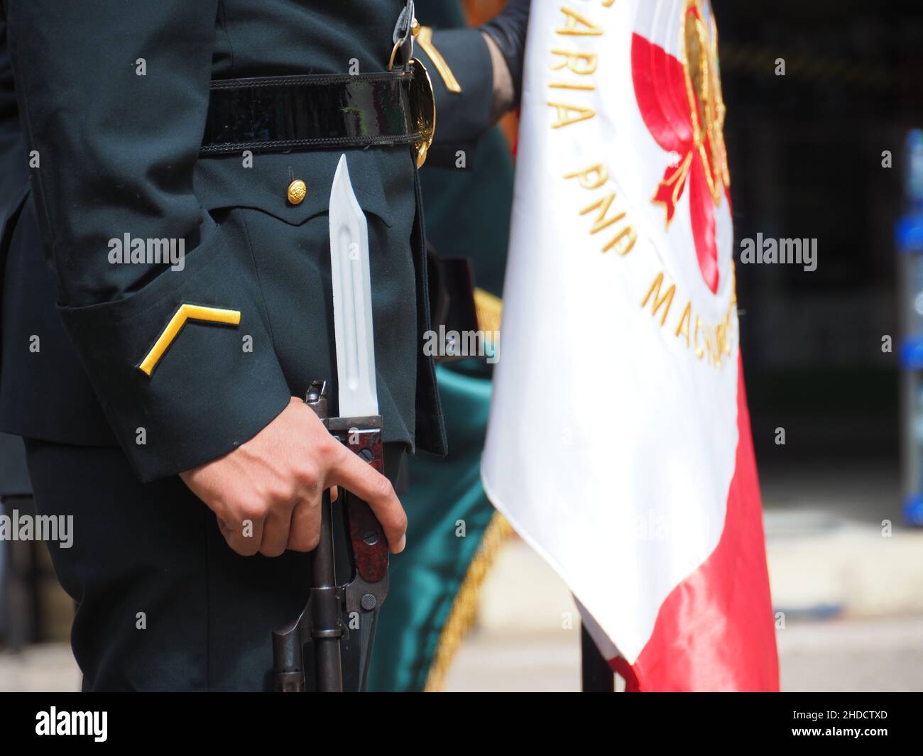 Peruvian police officer standing at attention with rifle and bayonet in ...