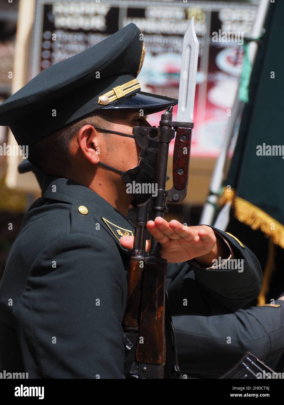 Peruvian police officer standing at attention with rifle and bayonet in ...