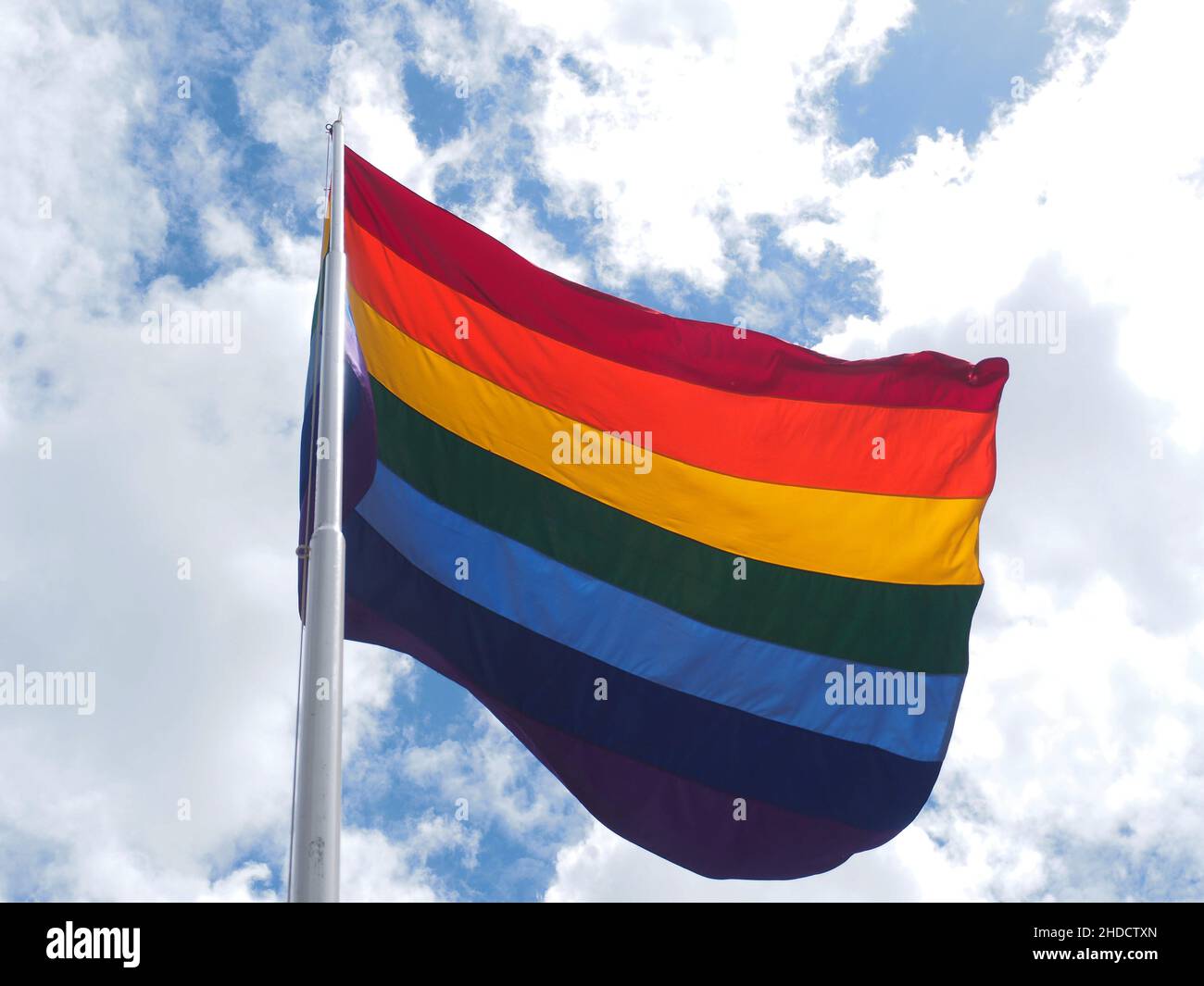 Flag of the city of Cuzco waving on a background of clouds. The ...