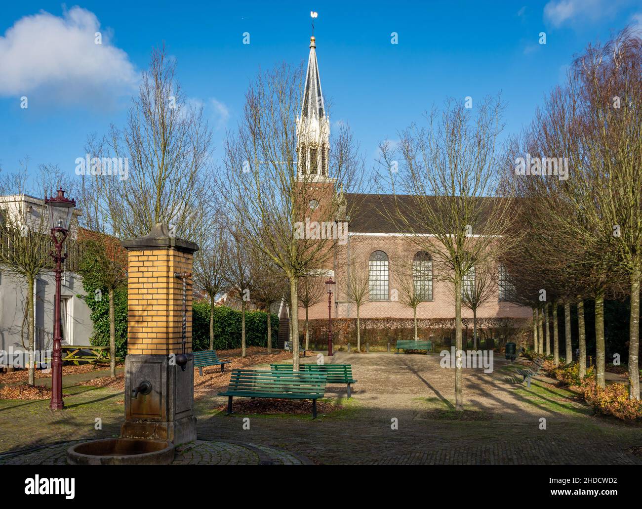 Old water pump and protestant church in the village of Sloten, North ...