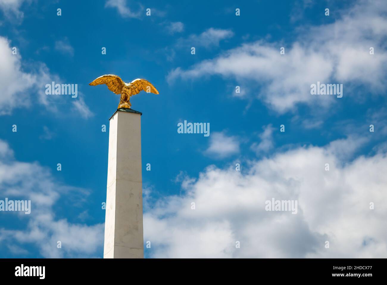 Closeup shot of a golden statue of an eagle on top of an obelisk tower ...