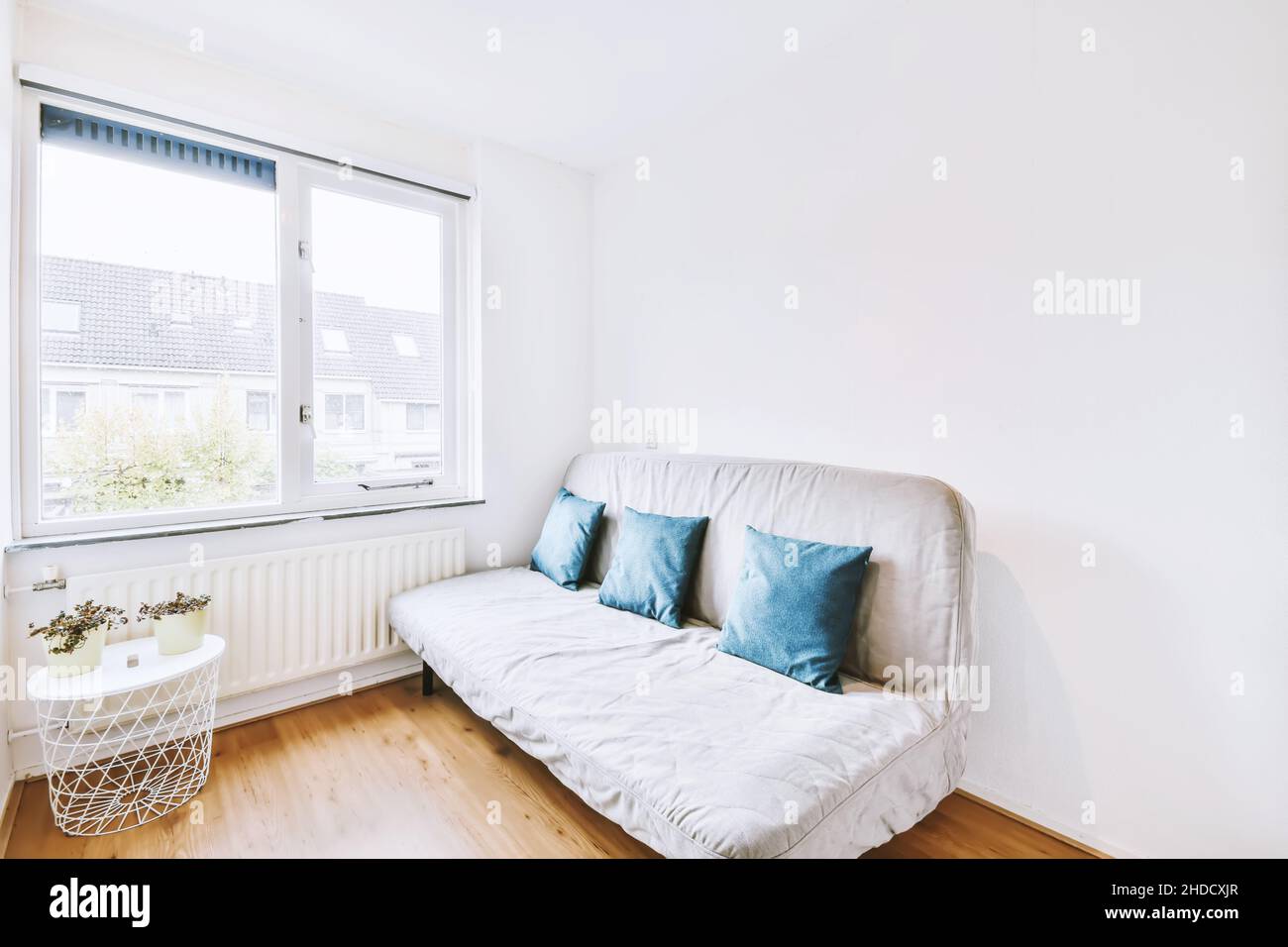 Set up small rooms with a sofa between two walls Stock Photo - Alamy