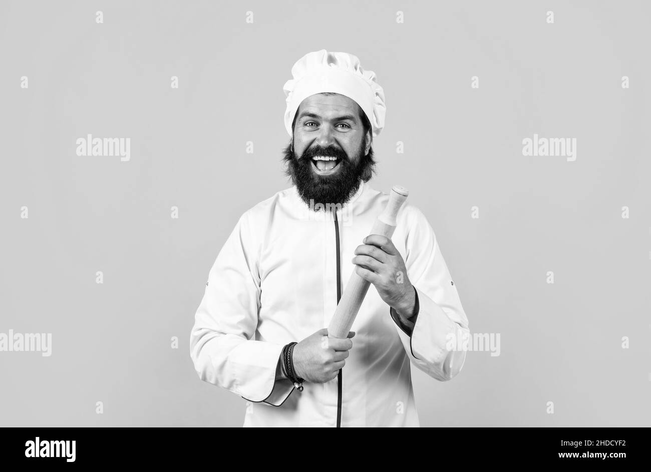 confident chef man with beard and moustache in cook uniform holding ...