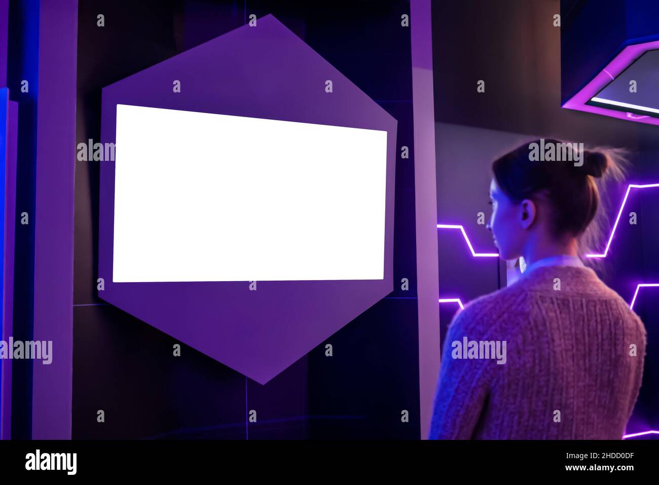 Woman looking at blank white display wall at exhibition - white screen ...