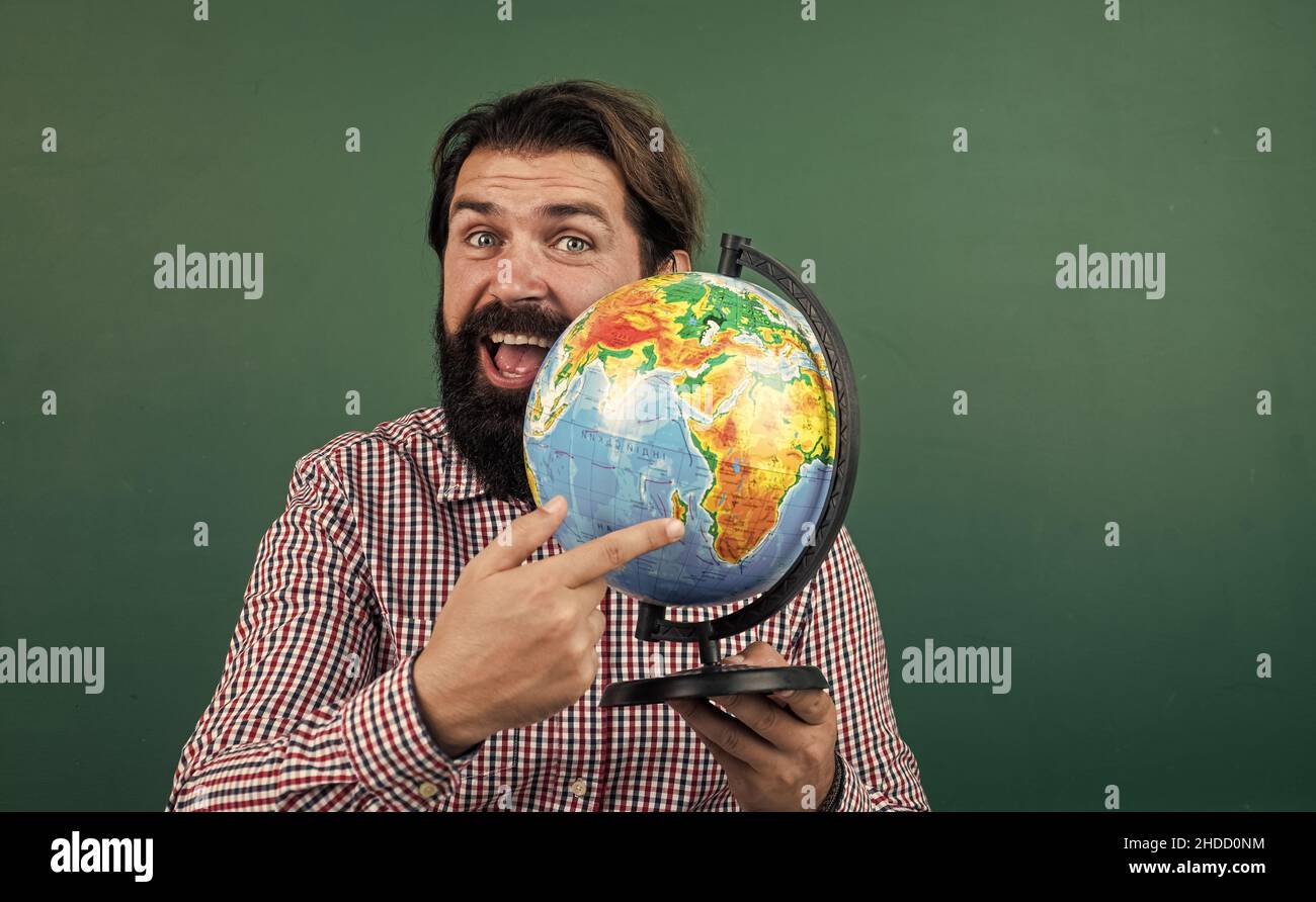 cheerful bearded man in checkered shirt holding geographic globe ...