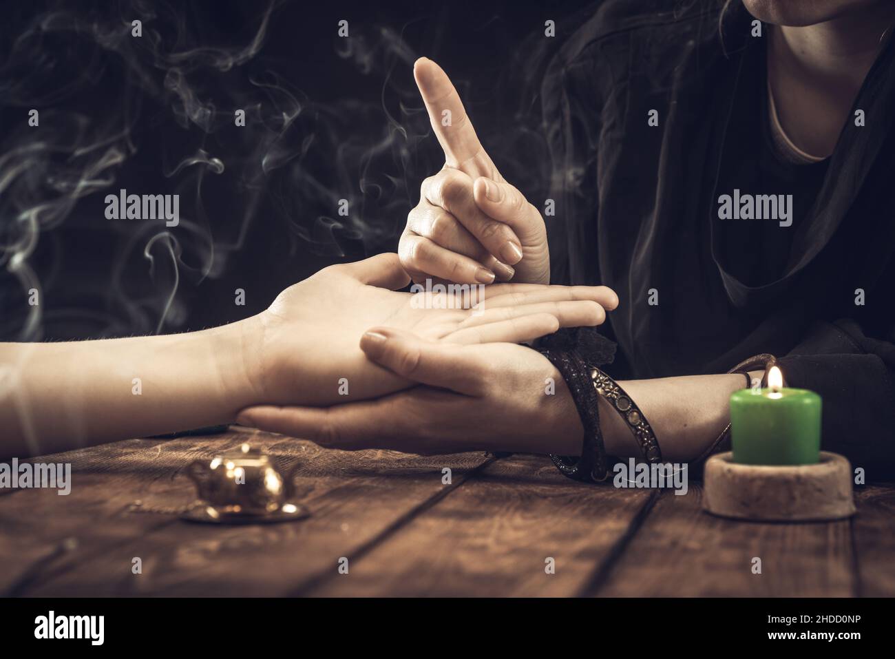 A fortune teller or oracle in search of the lines of fate in the palm ...