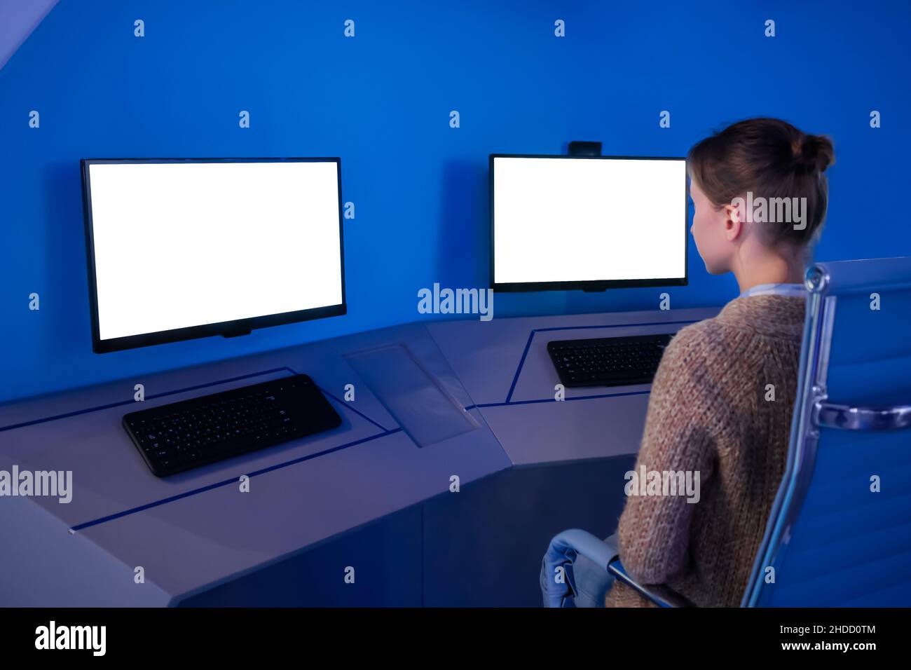 Woman looking at two monitors with white displays - mock up concept ...
