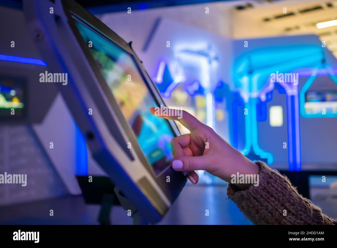 Woman hand using touchscreen display of floor standing tablet kiosk ...