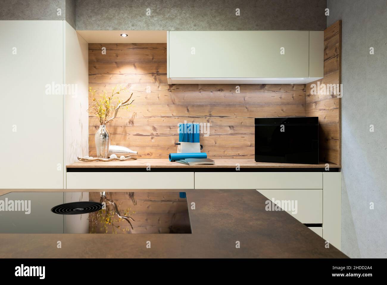 modern island stove, integrated extractor hood and wood look niche with ...