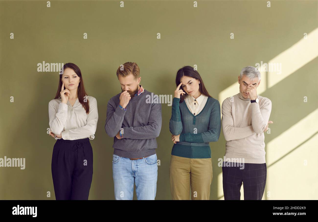 Group of serious adult people thinking hard trying to answer a ...