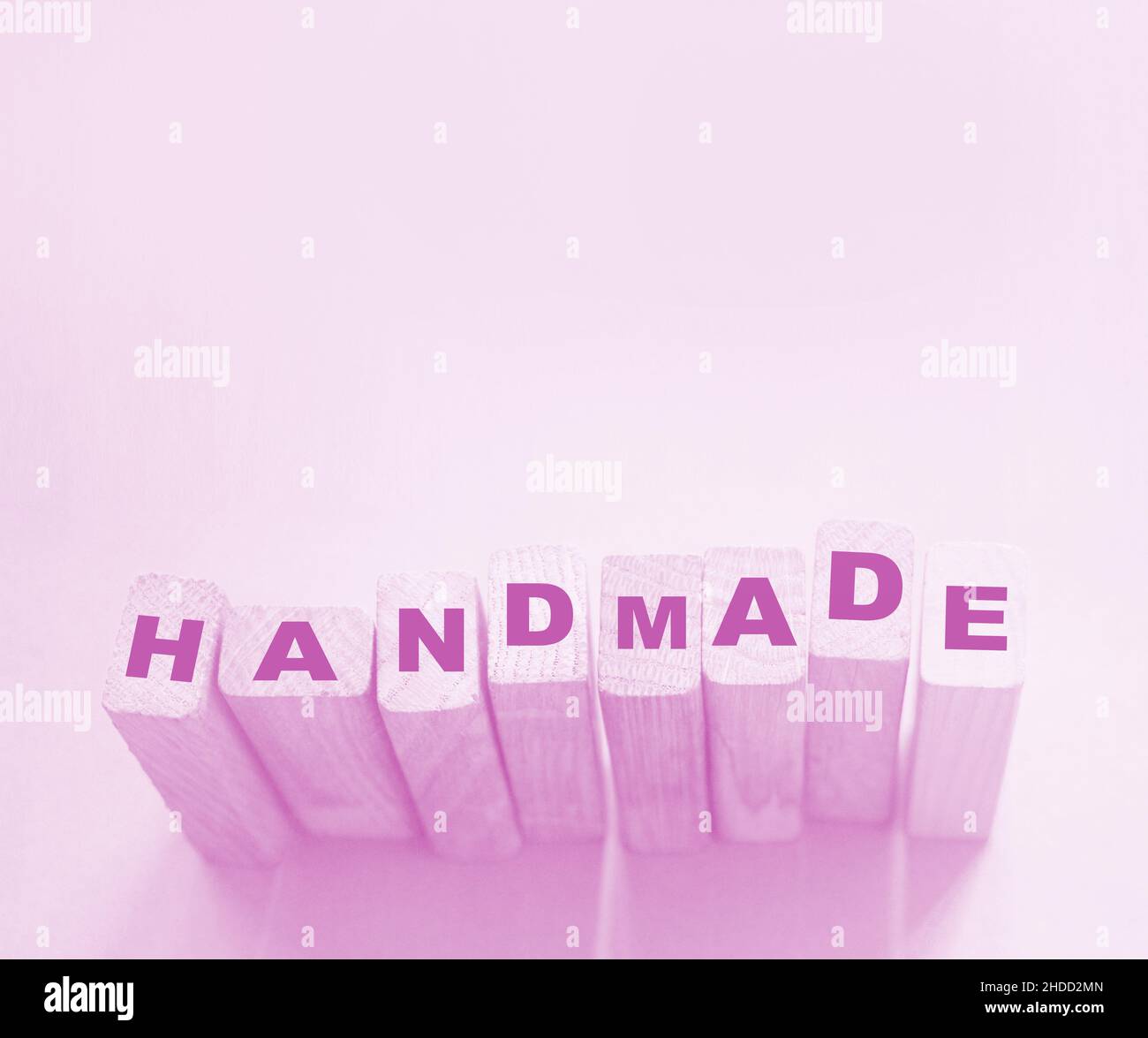 Handmade word on wooden blocks, light blue background. Hobby handmade ...