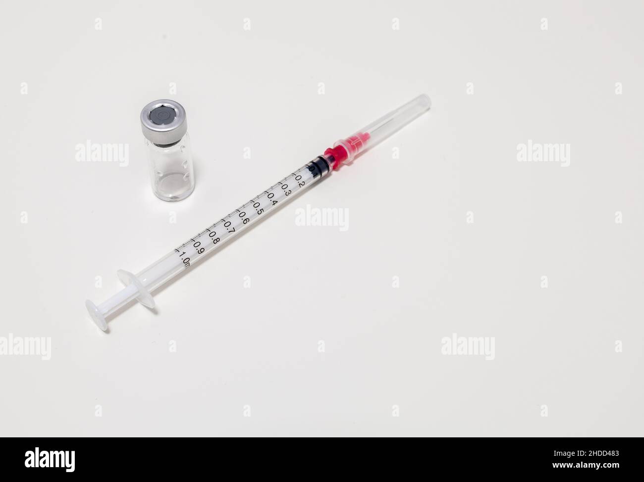 Top view of an empty syringe with a glass container on a white ...