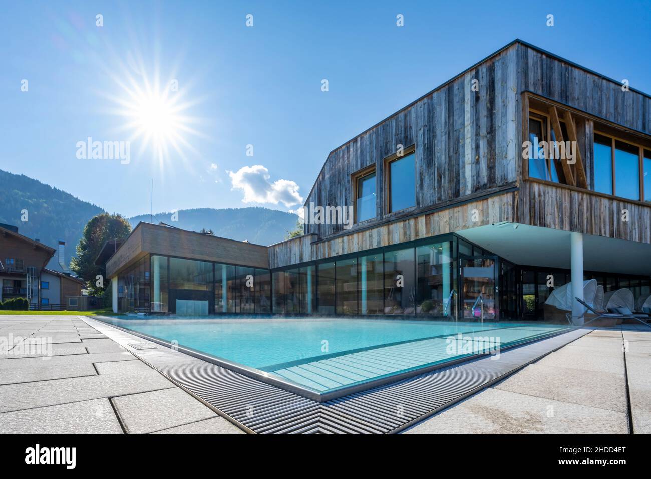 modern pool building with weathered wood facade with fresh turquoise ...