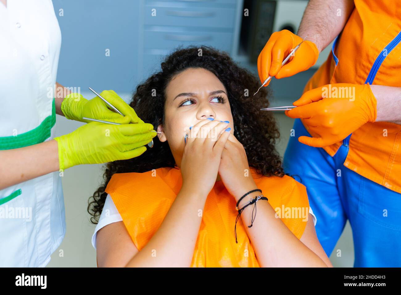 Dental fear concept. Dentophobia. Teenage girl being afraid of two ...