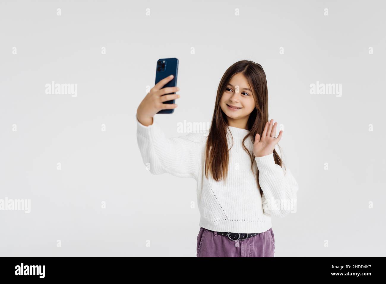 girl doing a video call on a white background Stock Photo - Alamy
