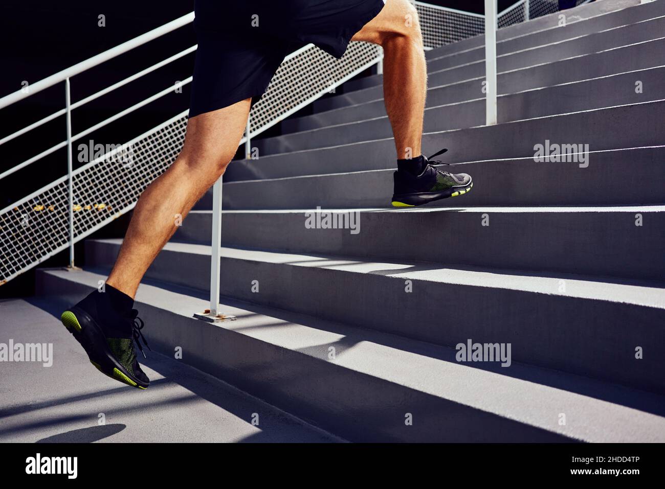 Athletic man running up staircase. Jogger working out Stock Photo - Alamy