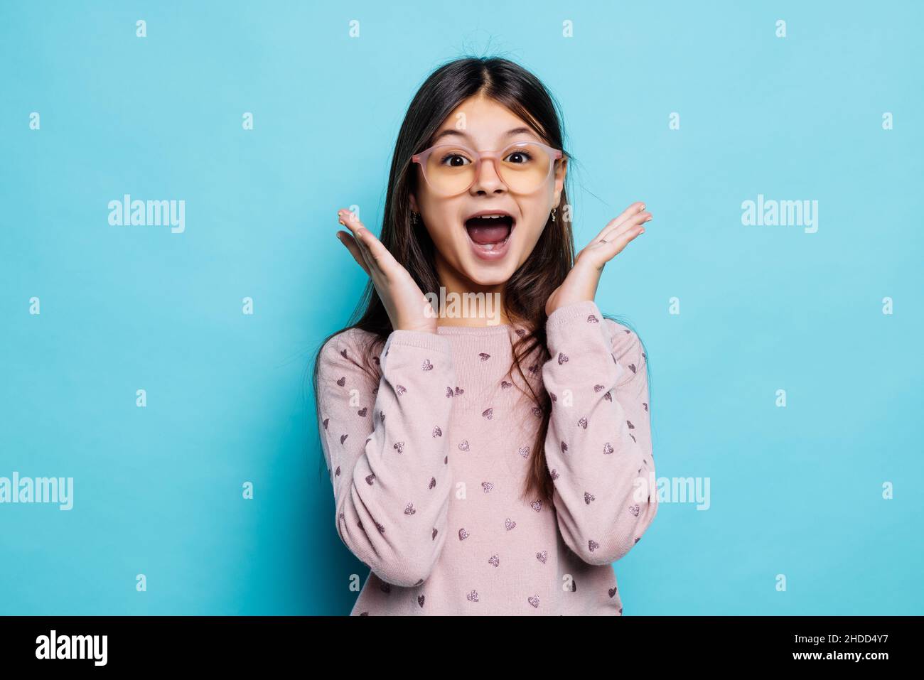 Portrait of desperate and shocked beautiful little girl wearing blue T ...