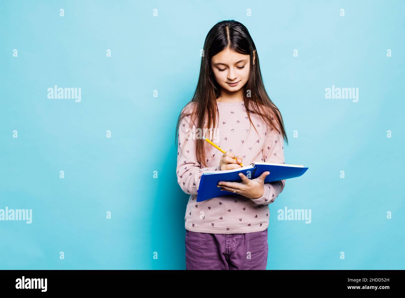 happy child making notes on blue background, childhood Stock Photo - Alamy
