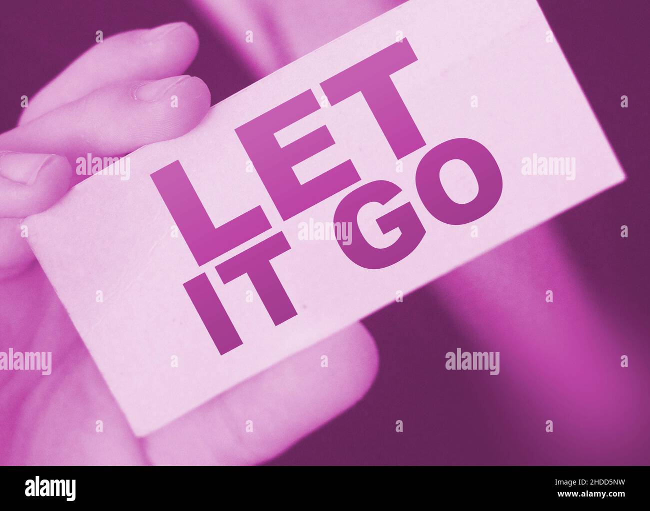 Closeup on businessman holding a card with text LET IT GO, business ...
