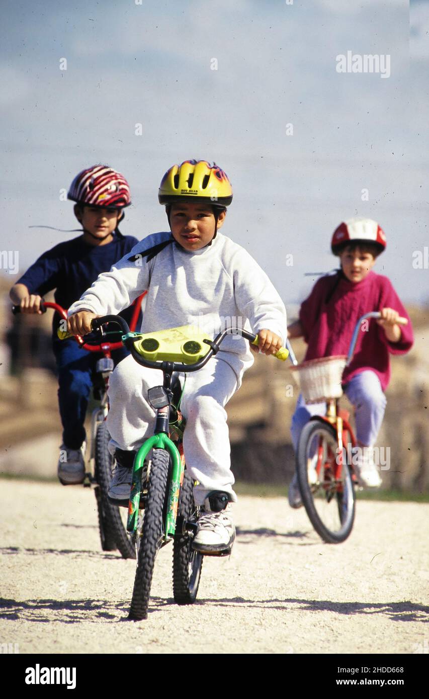 Austin Texas USA, 1994: Second- and third-grade students riding their ...