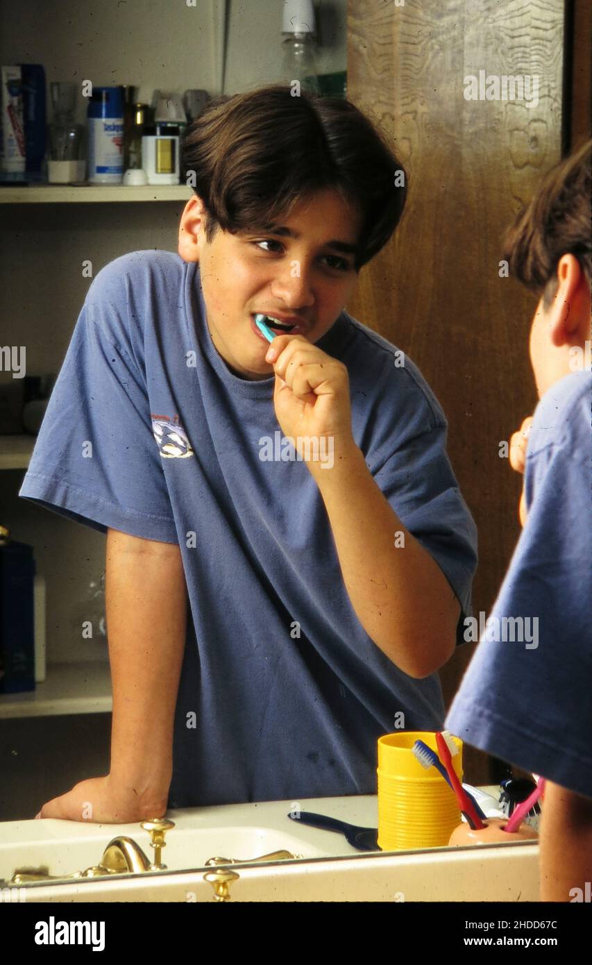 Teen boy brushing teeth hi-res stock photography and images - Alamy