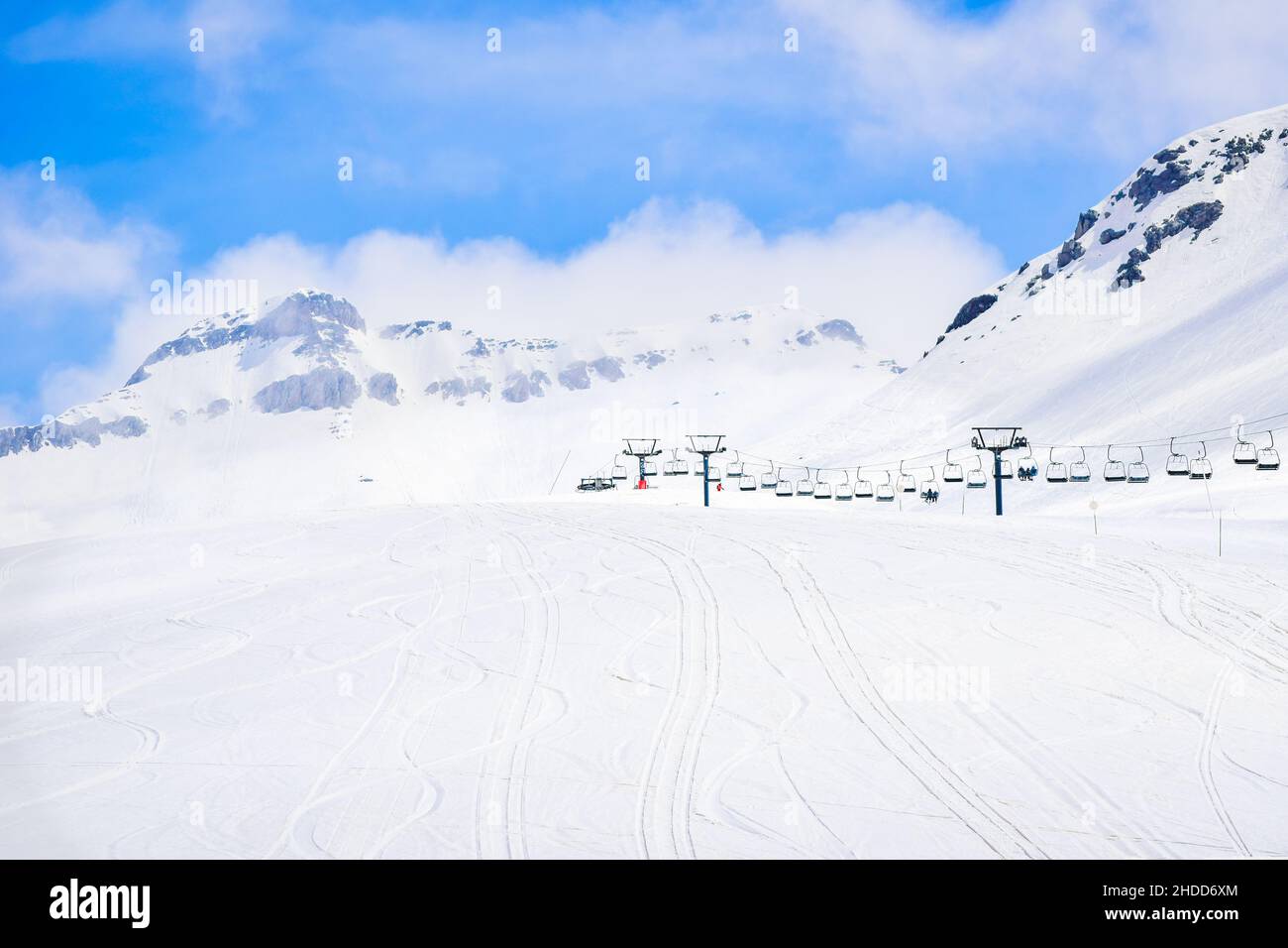 Empty beginner slope for learning with mountains background. Ski ...