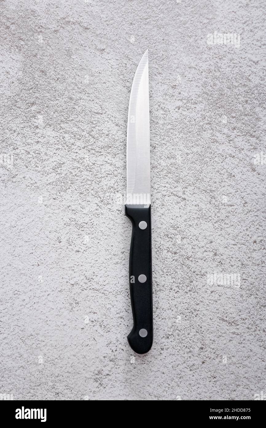 Steel kitchen knife on grey textured background, top view Stock Photo ...
