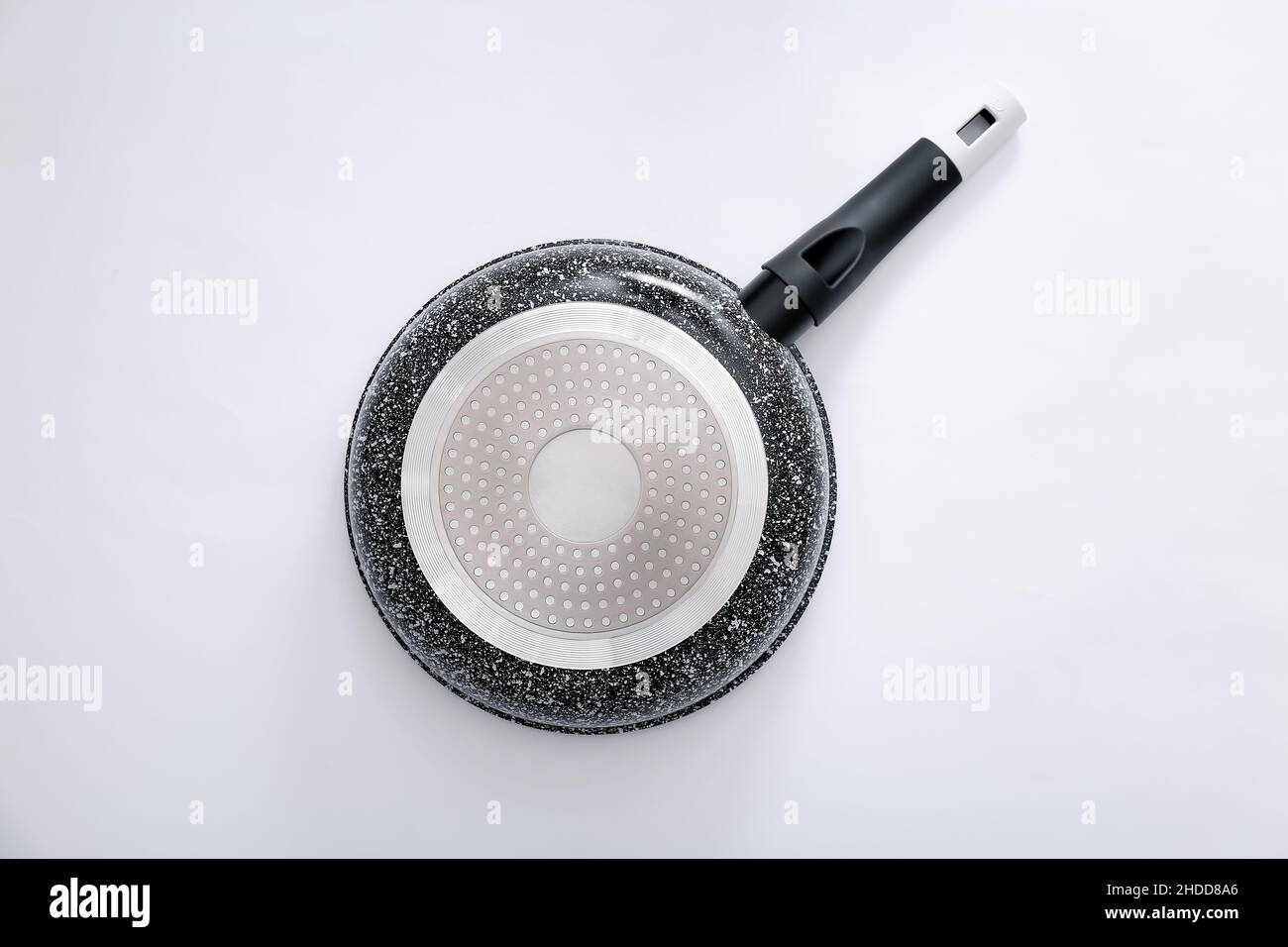 Back view of black marble frying pan on light grey background, top view ...