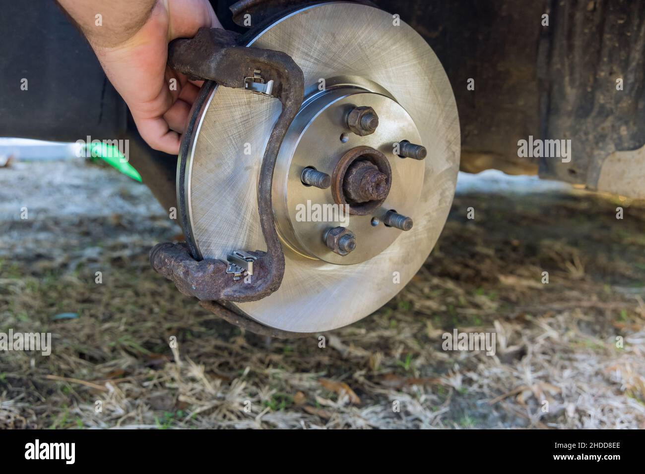 Brake disc and used brake pads on brake assembly service Stock Photo ...