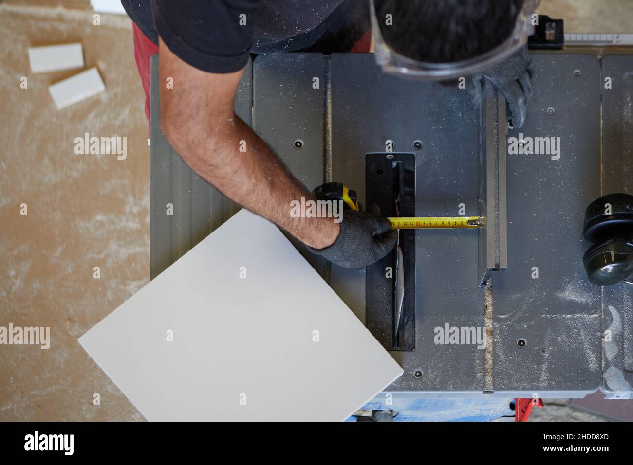 Top view of a man measuring table saw with a meter Stock Photo - Alamy