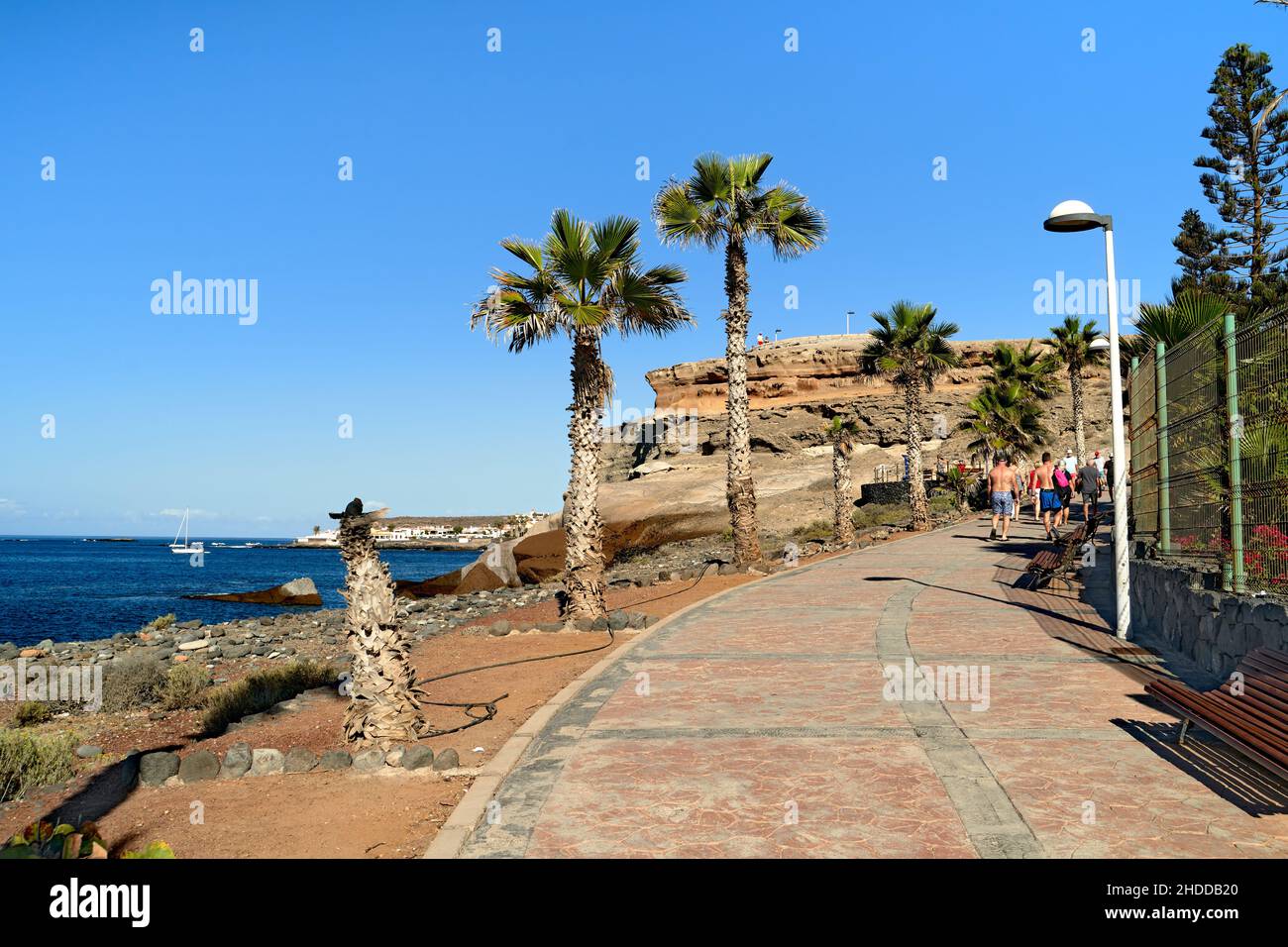 Tourists stroll along the promenade in La Caleta, Costa Adeje, Tenerife Stock Photo - Alamy