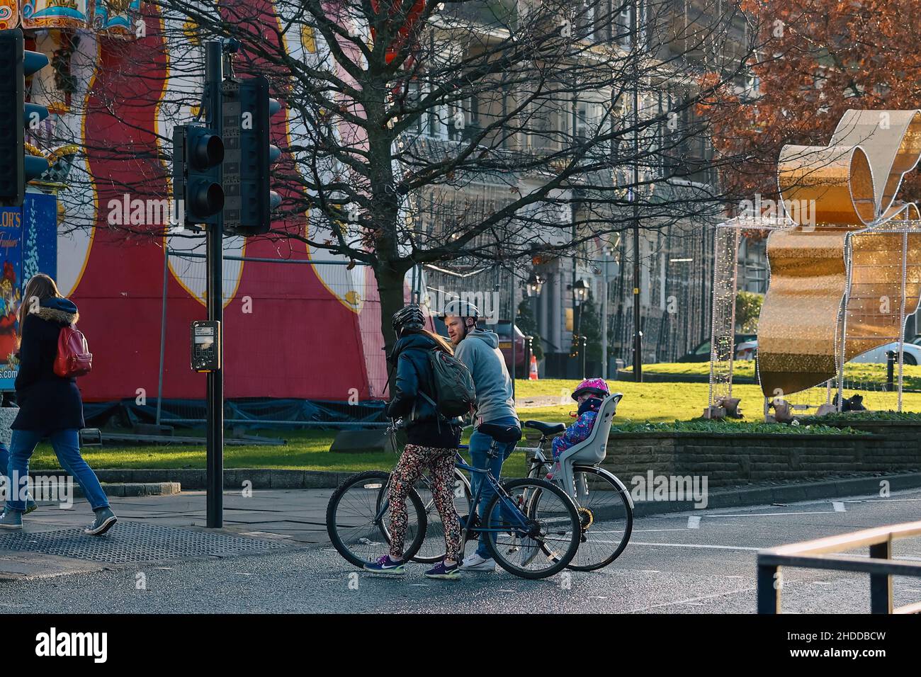 A family crossing traffic light with their bikes and child Stock Photo ...
