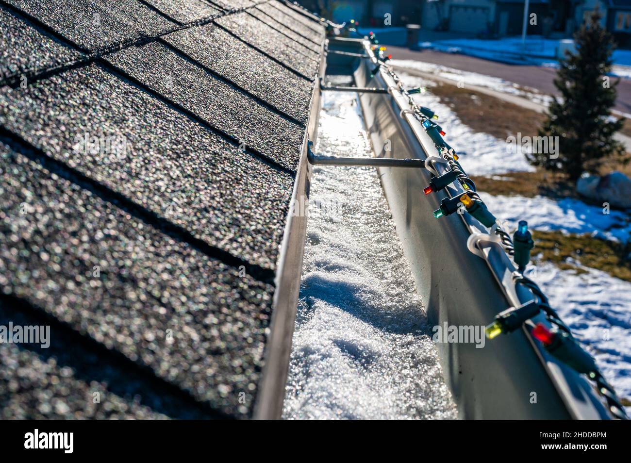 Ice and snow building up inside a rooftop gutter system on a ...