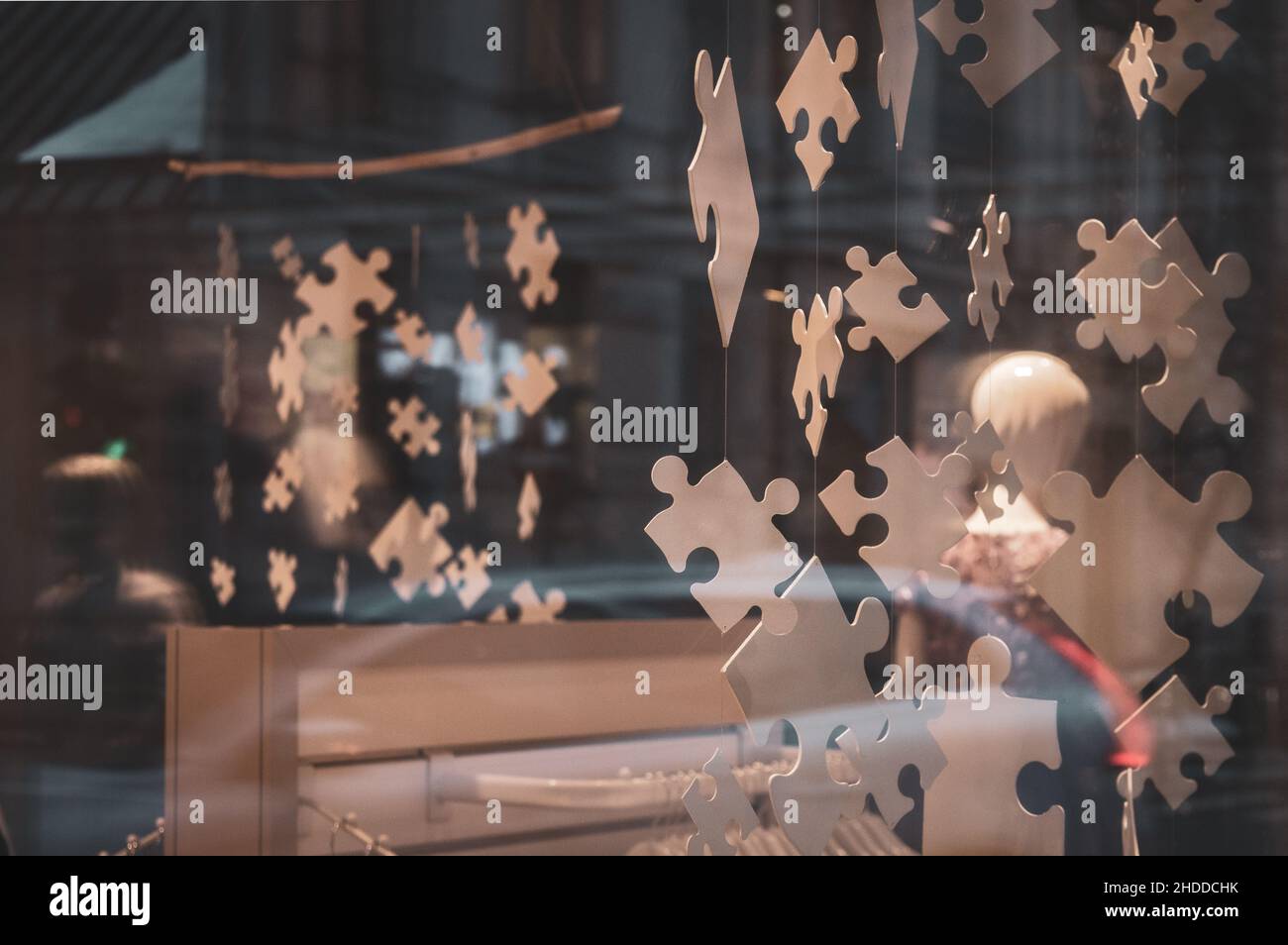 Pieces of puzzle decoration hanging from the ceiling. shopping window ...