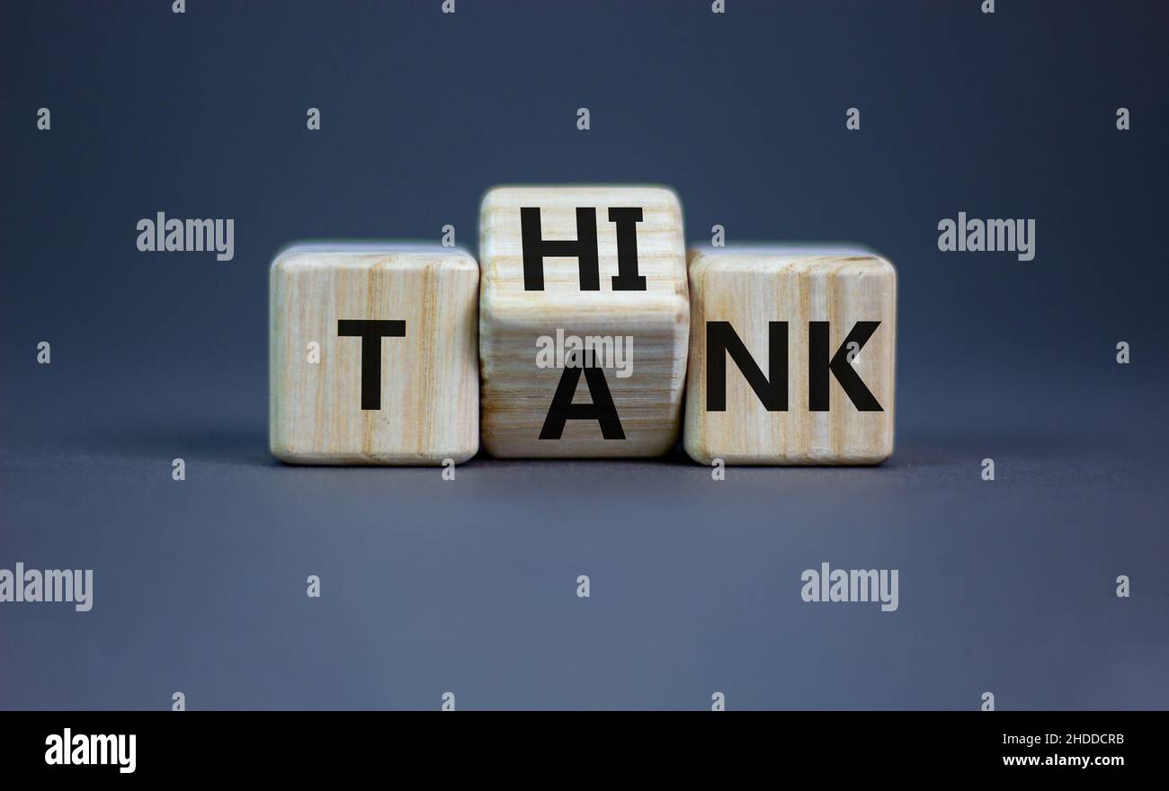 Think tank symbol. Businessman turns a wooden cube and changes the word ...