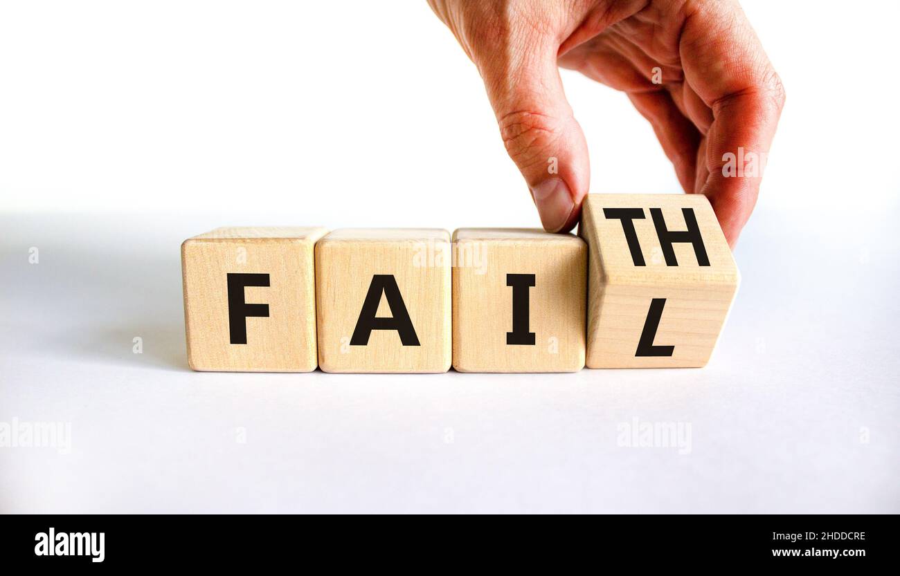 Faith instead fail symbol. Businessman turns a wooden cube and changes ...