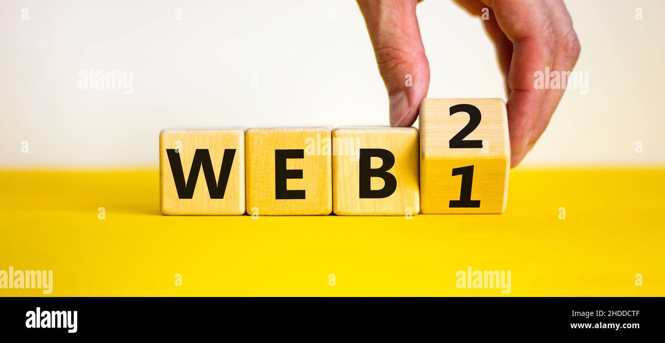 WEB 1 or 2 symbol. Businessman turns a wooden cube and changes words ...