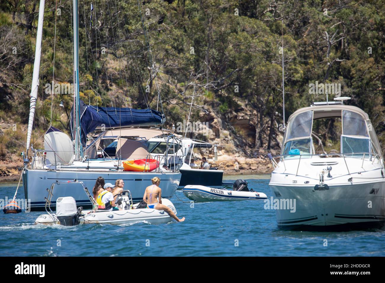 Teenagers in an inflatable dinghy on Pittwater at the basin campground ...