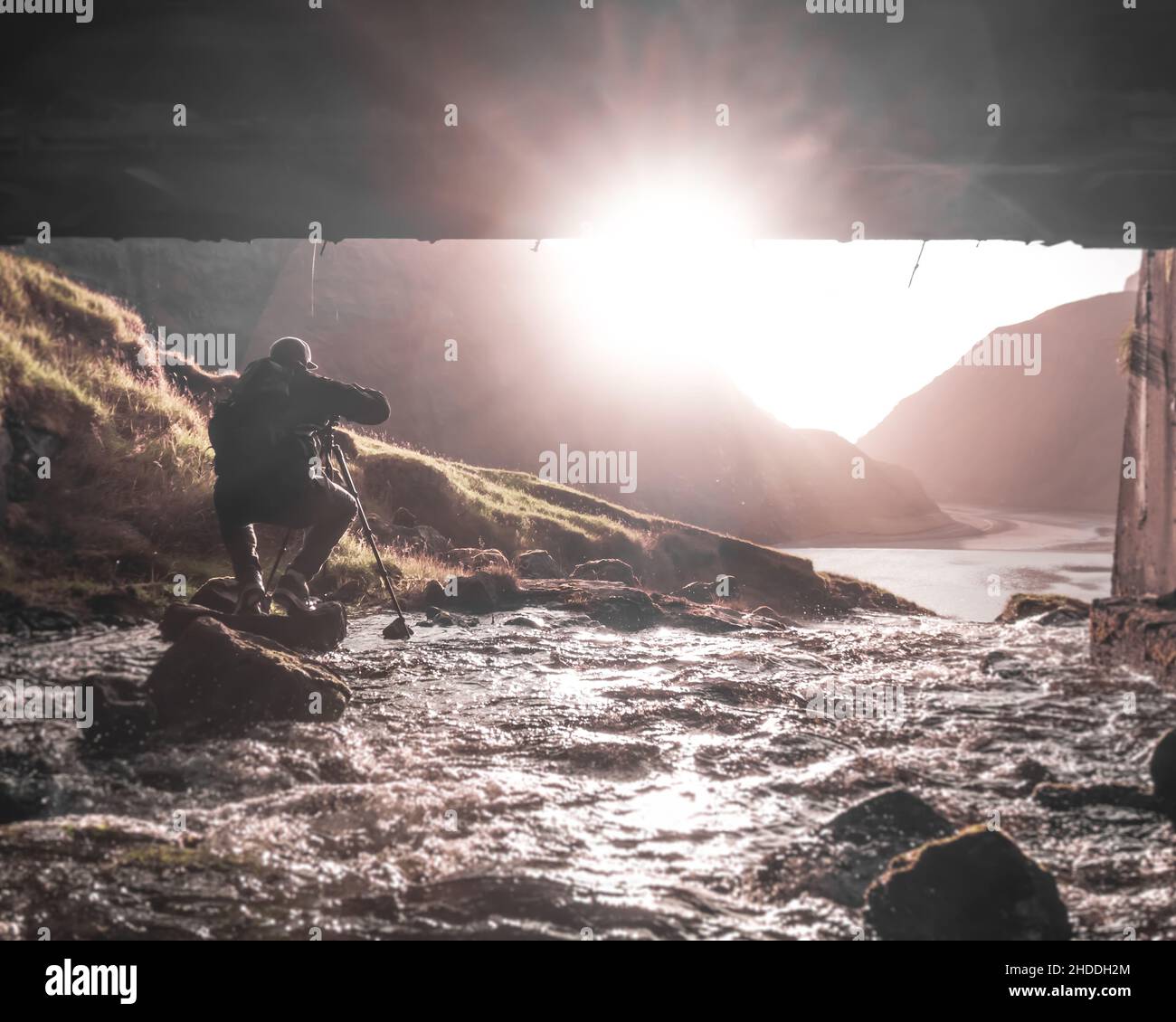 Back view of a man photographing under a bridge Stock Photo - Alamy