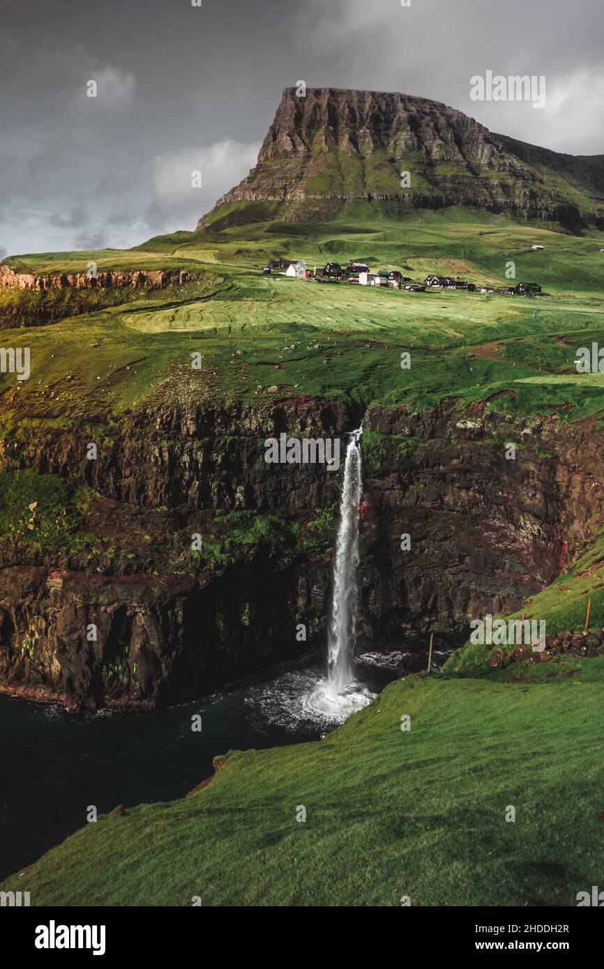 Most famous landmark of the Faroe Islands, a waterfall flowing down ...
