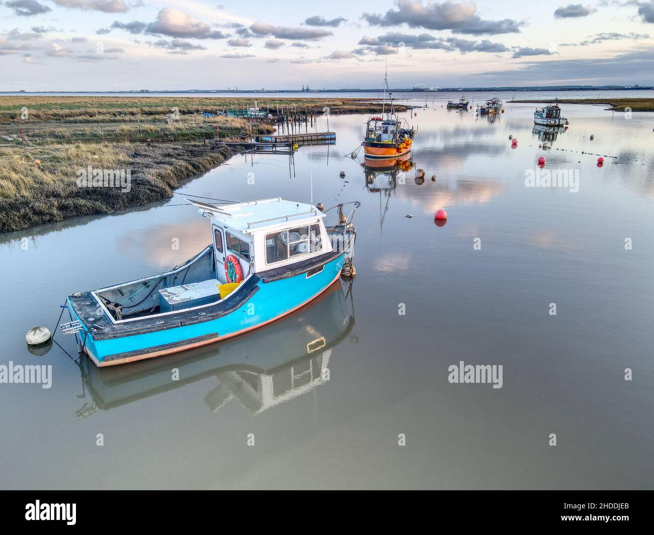 Small shipping boats moored in tranquil harbour Stock Photo - Alamy