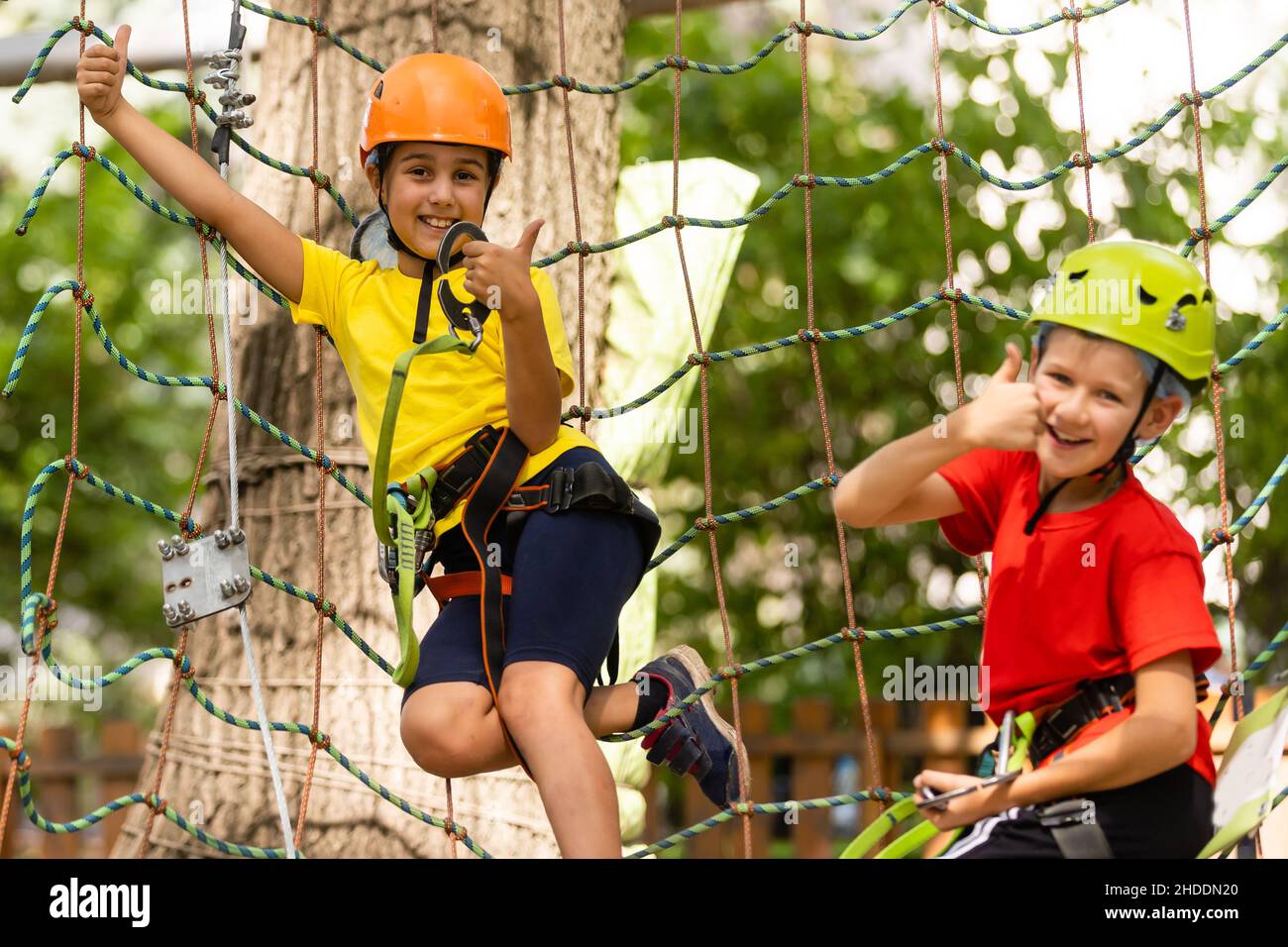 Happy child climbing in the trees. Rope park. Climber child. Early ...