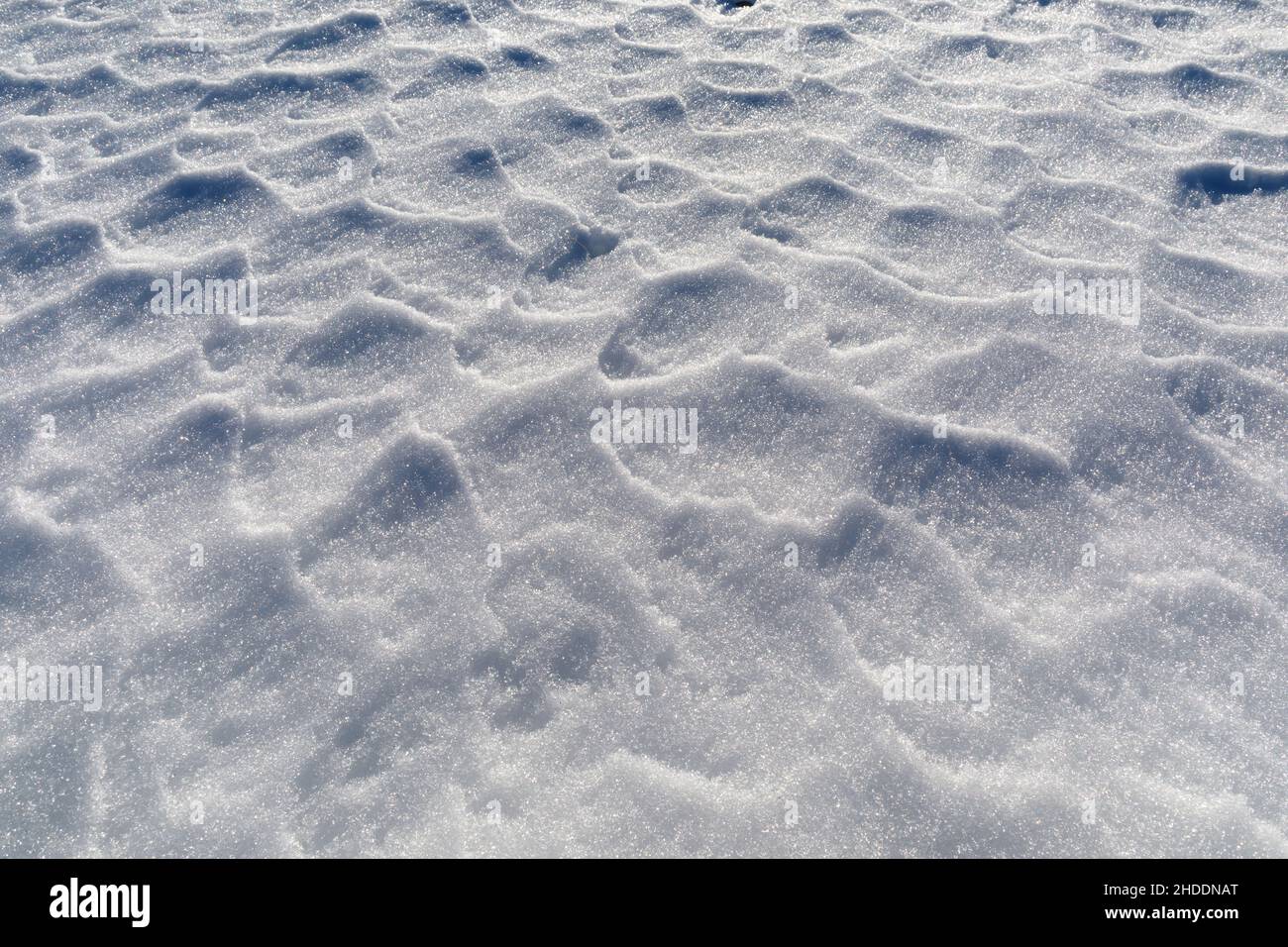 The snow rippled by the wind creates small reliefs on the surface of ...