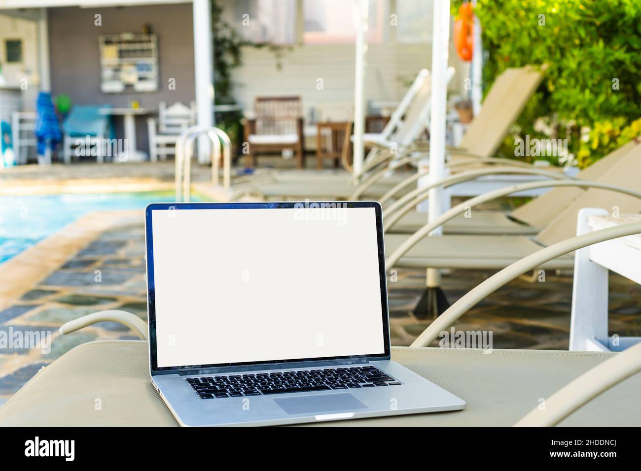 laptop on a sun lounger by the pool Stock Photo - Alamy