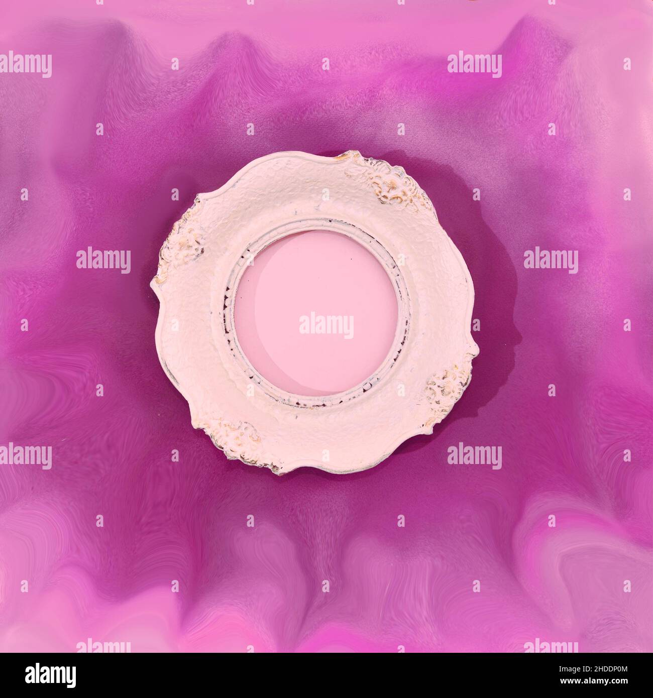A beige vintage oval frame on pastel pink and magenta background ...