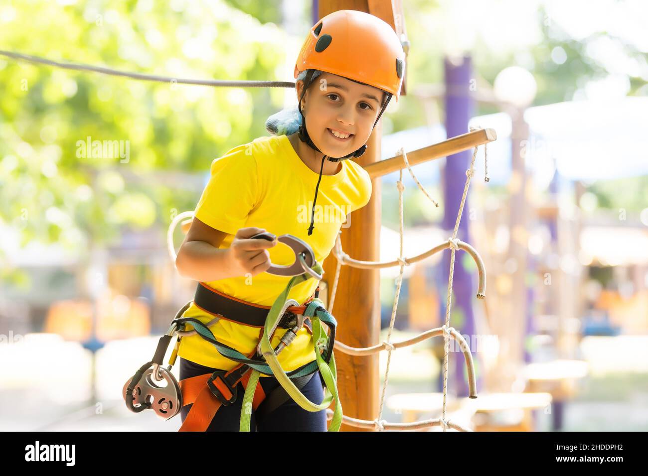 Happy child climbing in the trees. Rope park. Climber child. Early ...